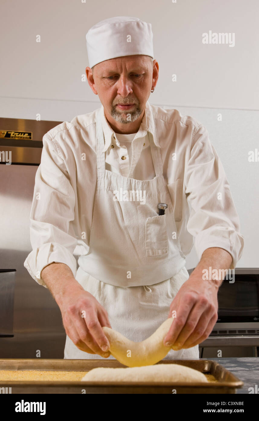 Professional cook preparing fresh bread in a commercial bakery Stock ...