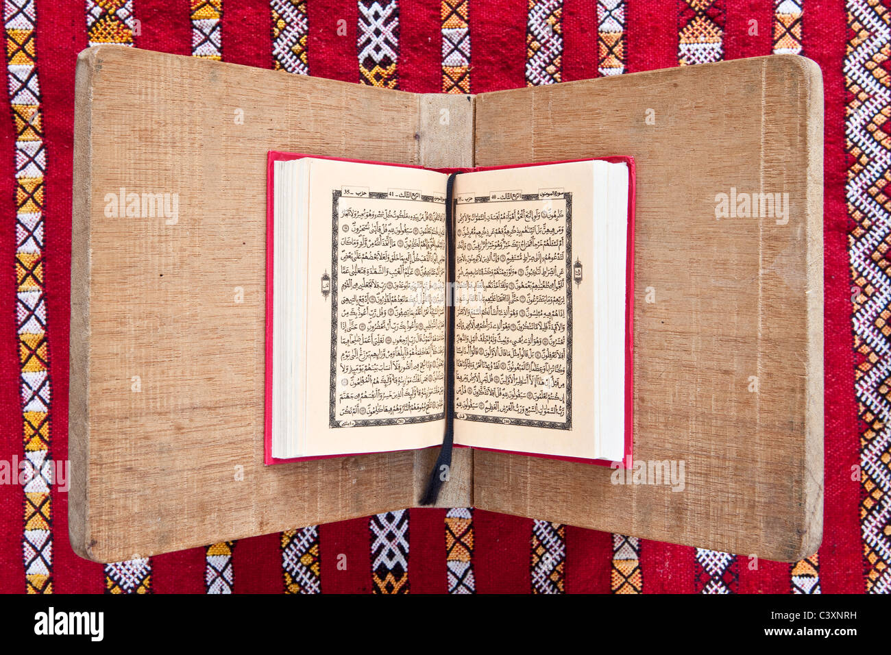 Arabic quran in Warsh style open on a wooden quran seat Stock Photo - Alamy