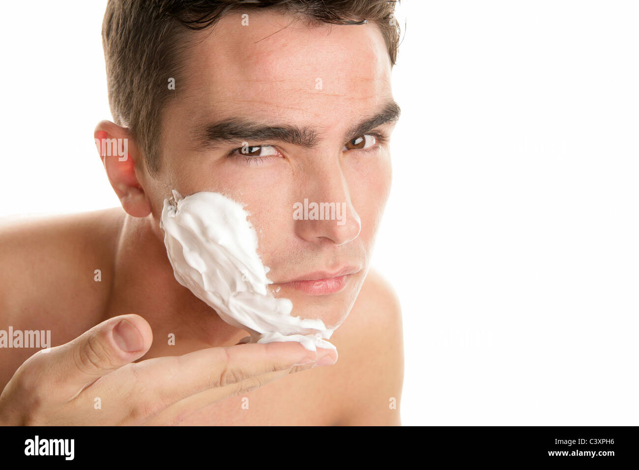 Man applying shaving cream on his face Stock Photo - Alamy