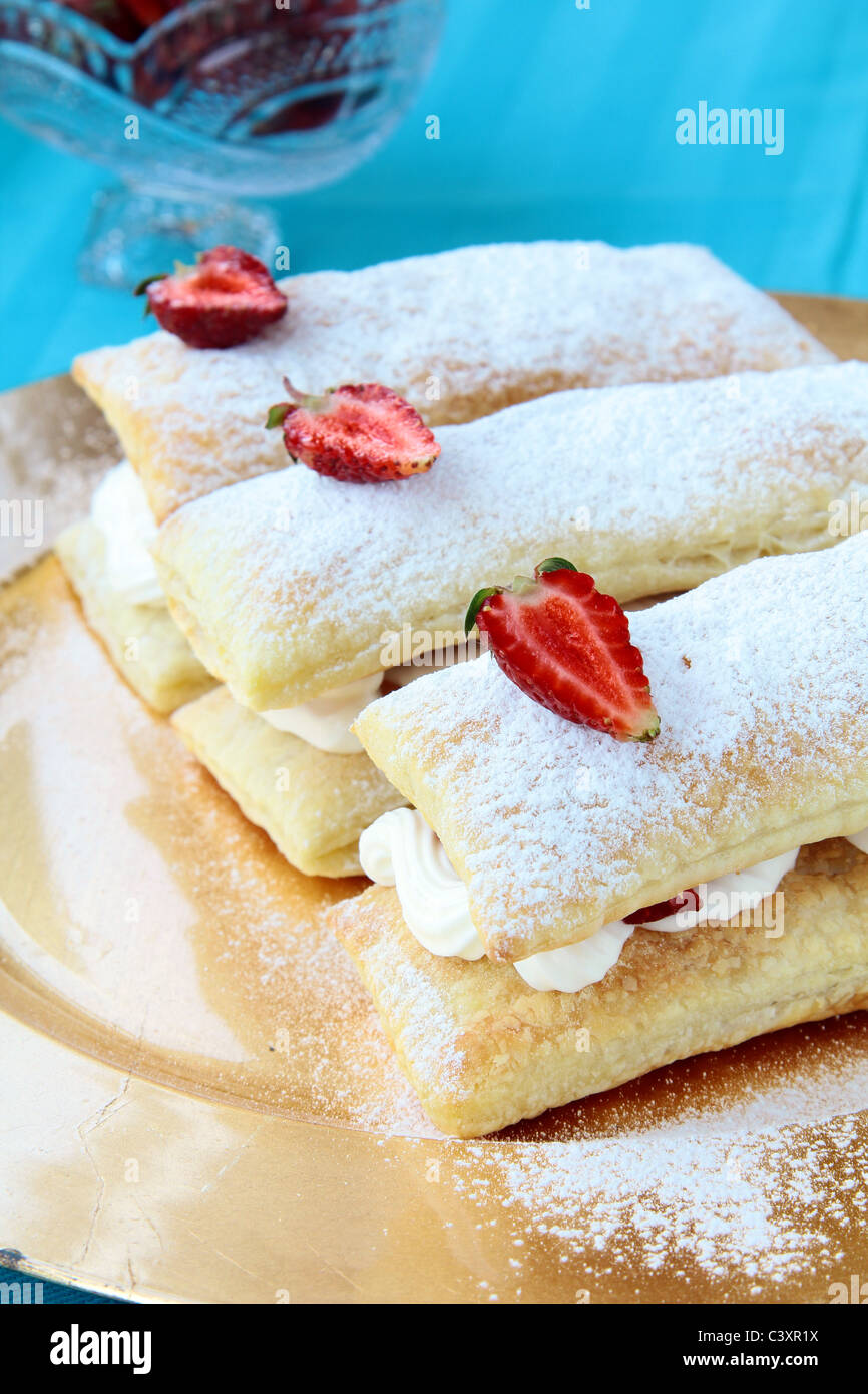 dessert cake of puff pastry, whipped cream and strawberries Stock Photo ...