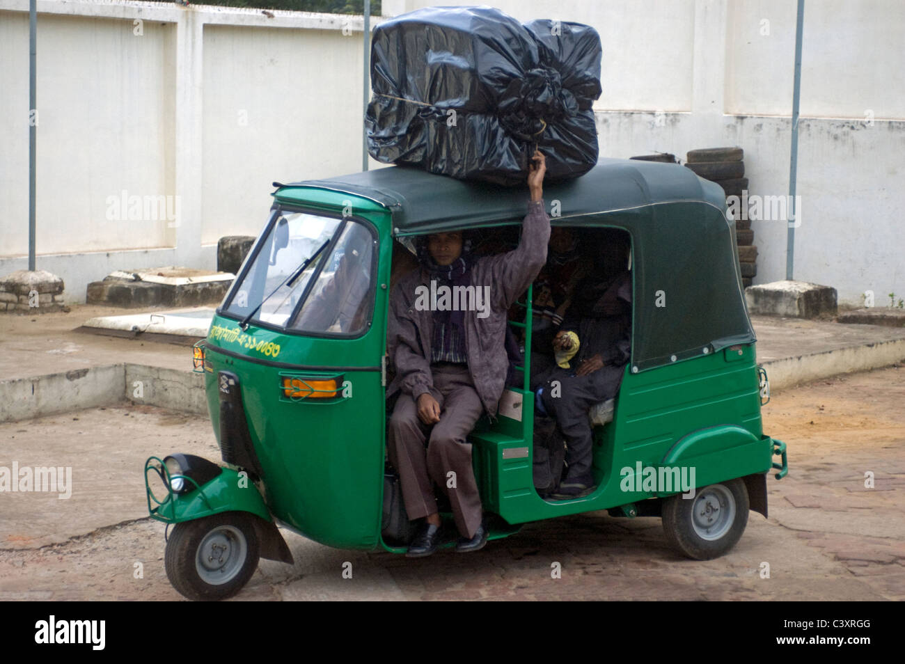 People ride in a tuk tuk Stock Photo - Alamy