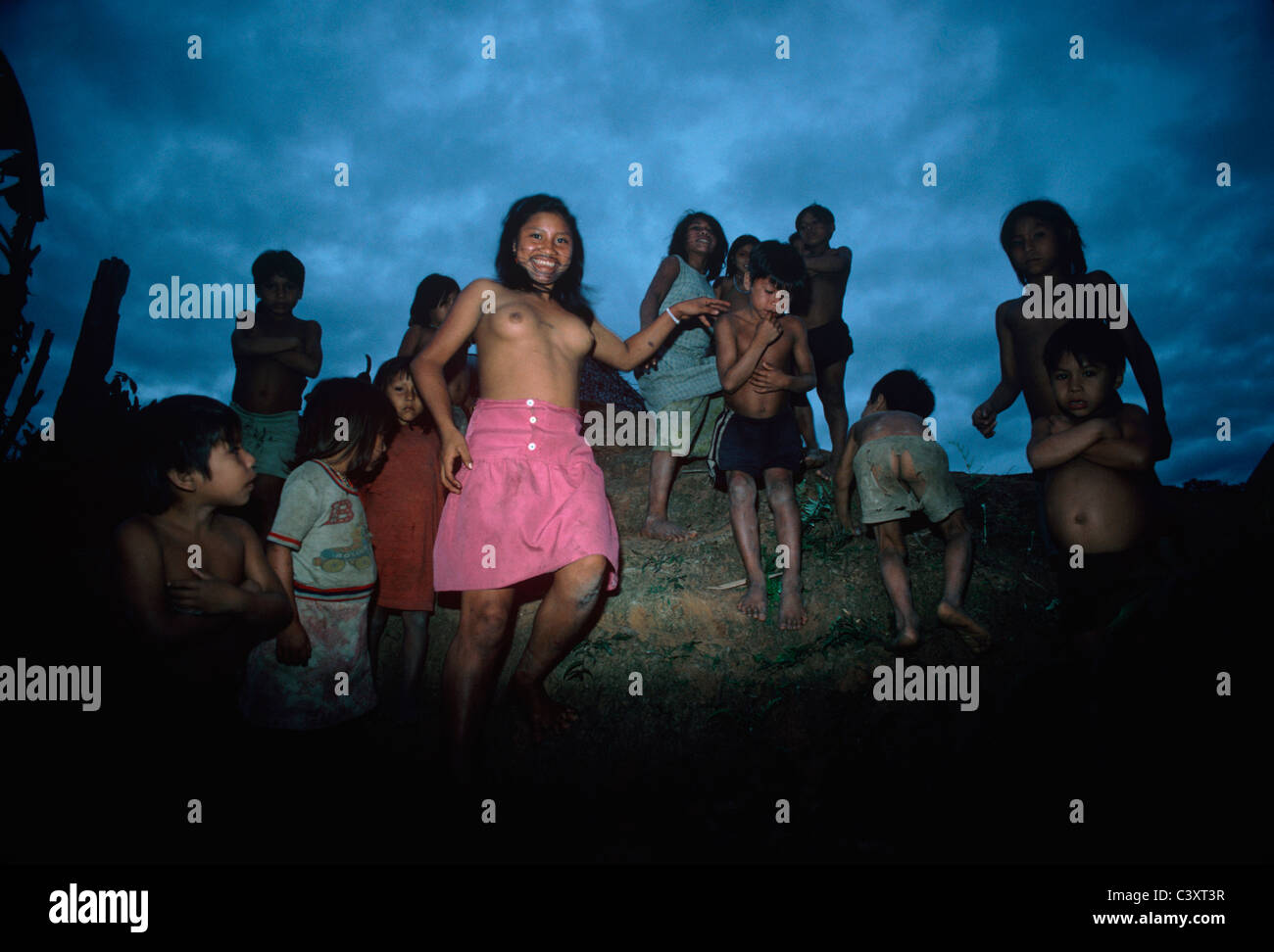 A group of children and adolescents of the Matses Indians of Peru sit ...