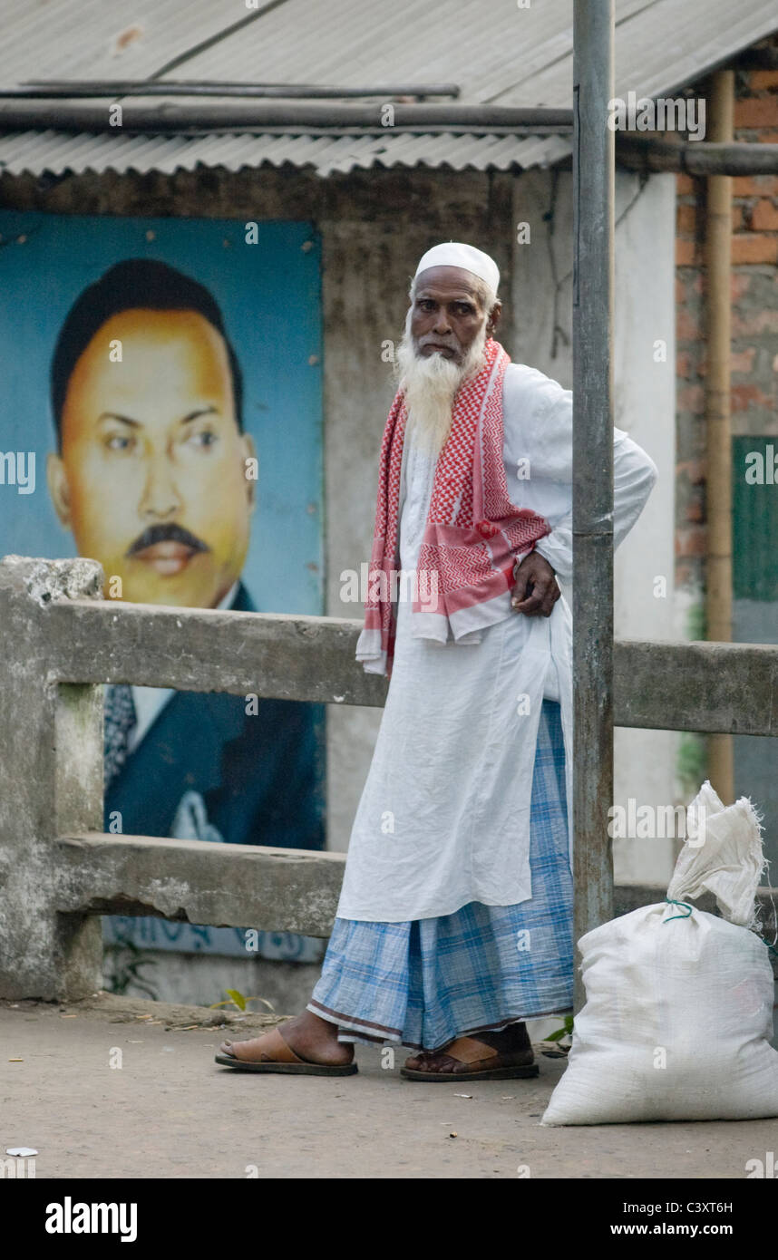 An old man leans against a fence Stock Photo - Alamy
