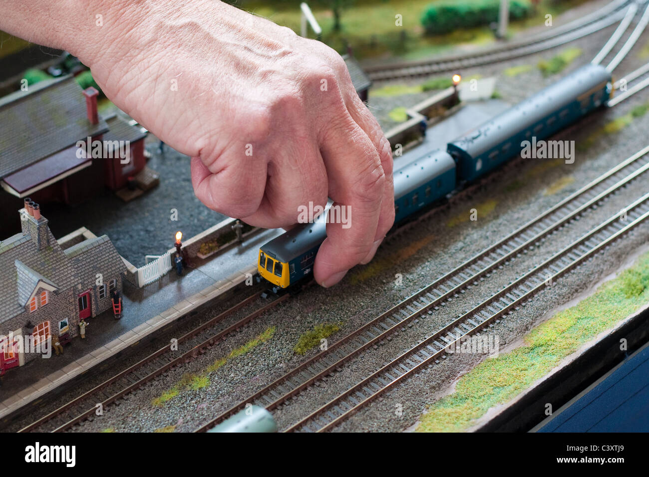 Model train enthusiast placing a carriage on the track. Risby model ...
