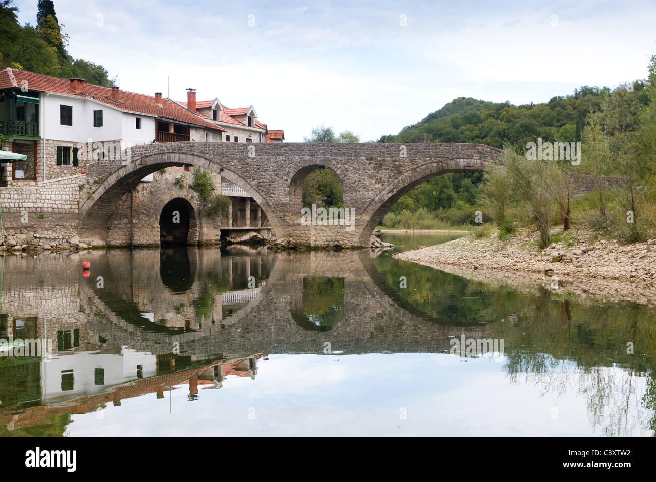 old bridge in the village Rijeka Crnojevica reflecting in the water in Montenegro Stock Photo ...