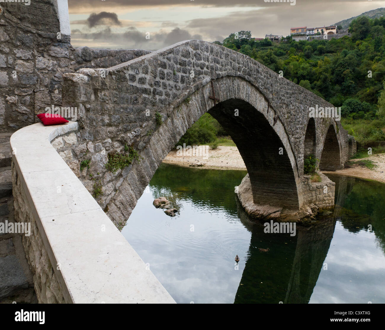 old bridge in the village Rijeka Crnojevica reflecting in the water in Montenegro Stock Photo ...
