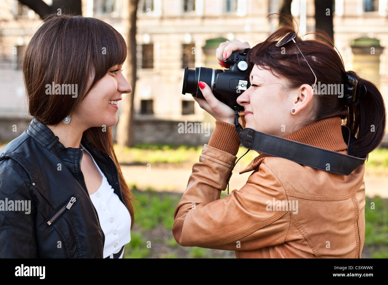 Woman photographer photographing the female model in outdoors Stock ...