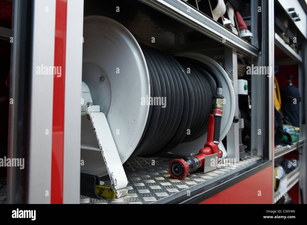 Fire engines, water hoses, nozzles and other equipment at a fire ...