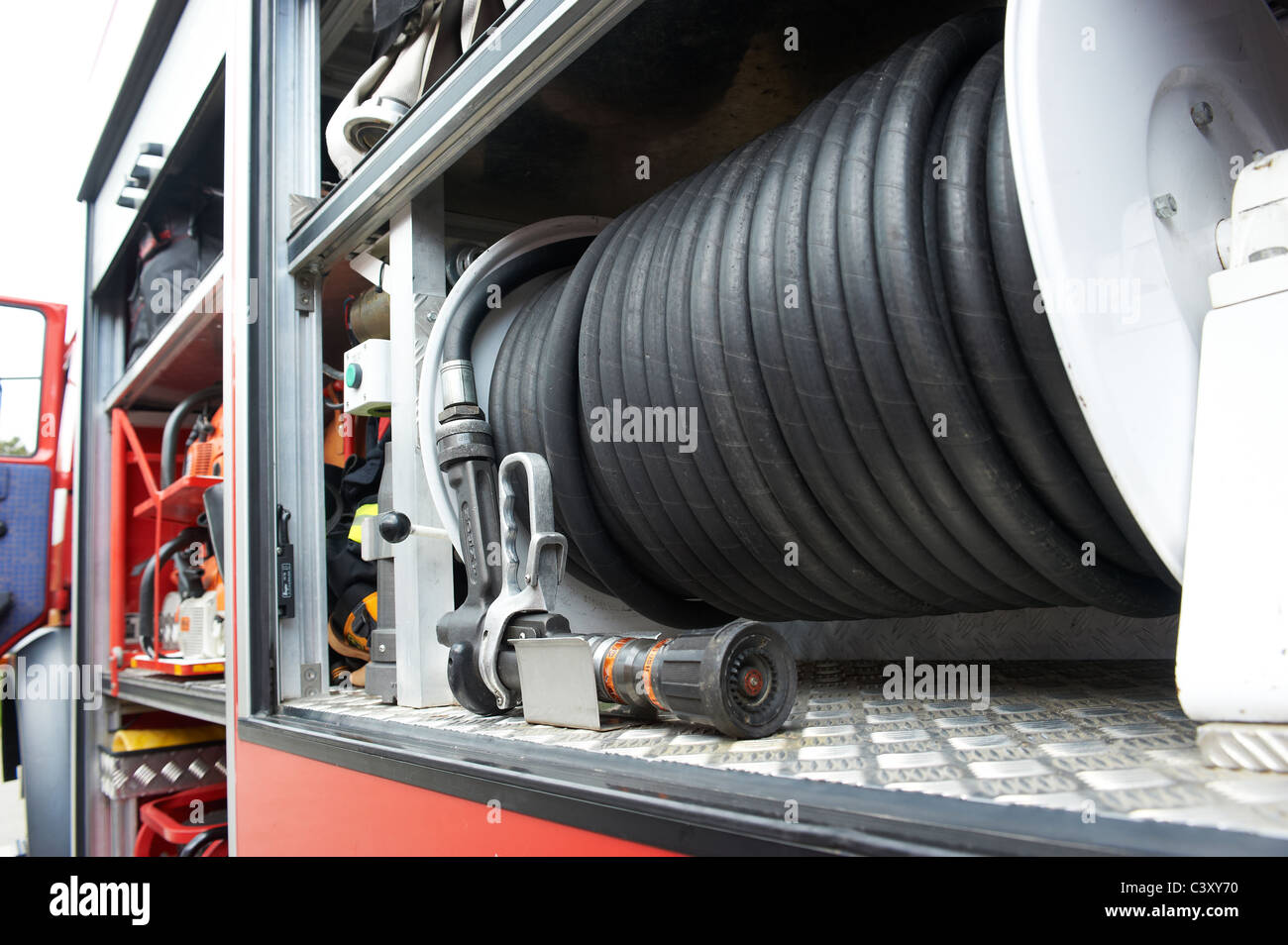Fire engines, water hoses, nozzles and other equipment at a fire ...