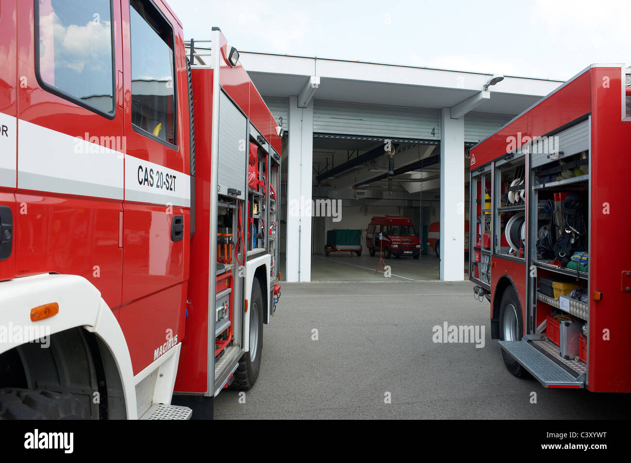 Fire engines, water hoses, nozzles and other equipment at a fire ...