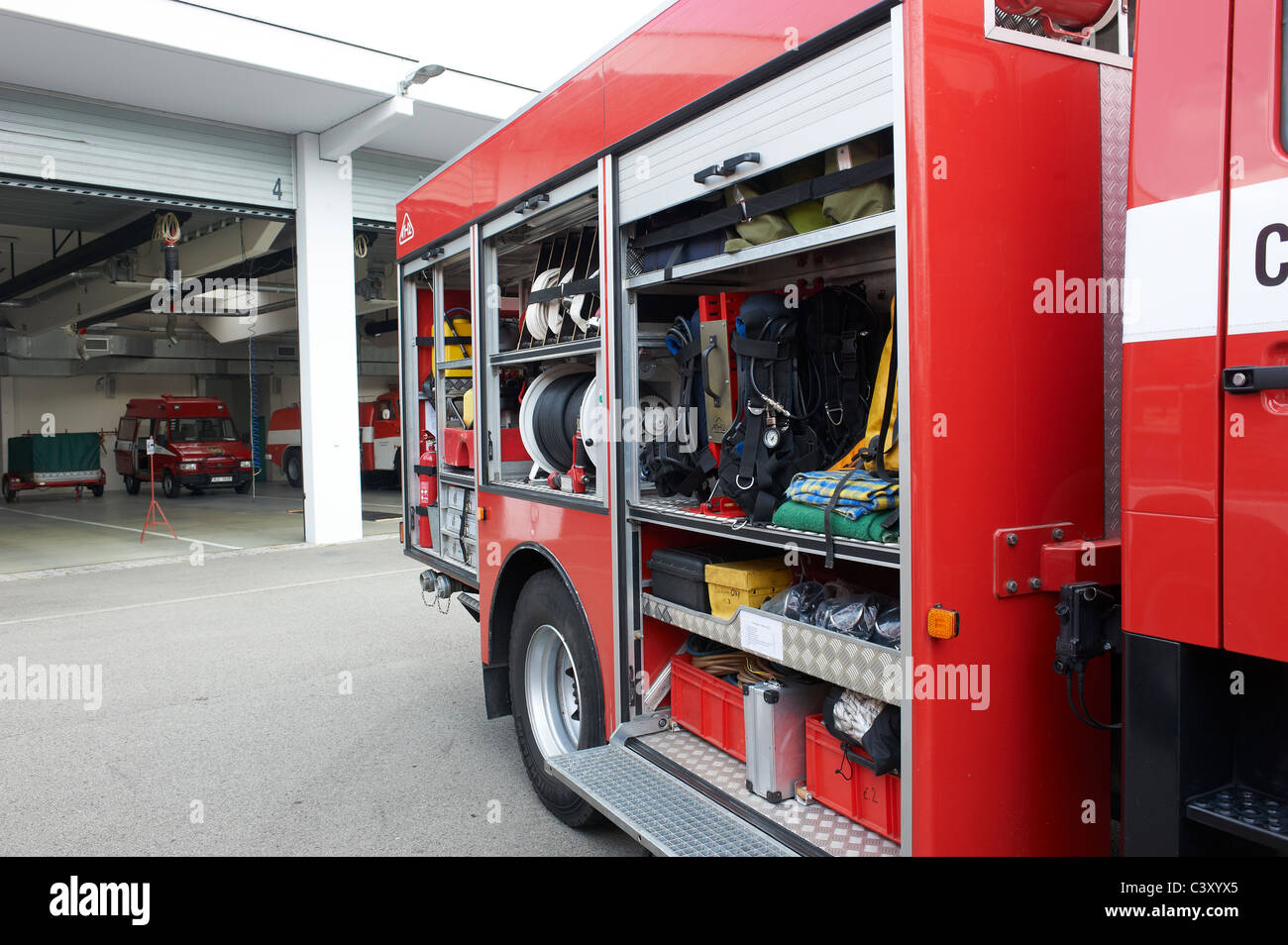 Fire engines, water hoses, nozzles and other equipment at a fire ...