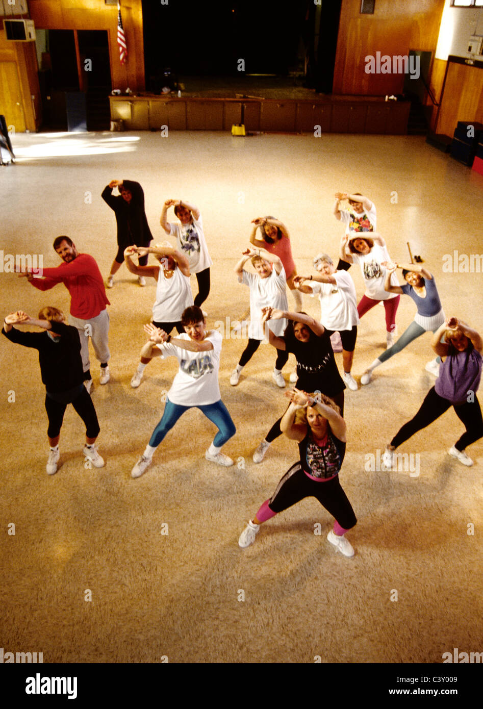adults woman follow aerobic instructor in physical fitness class at ...