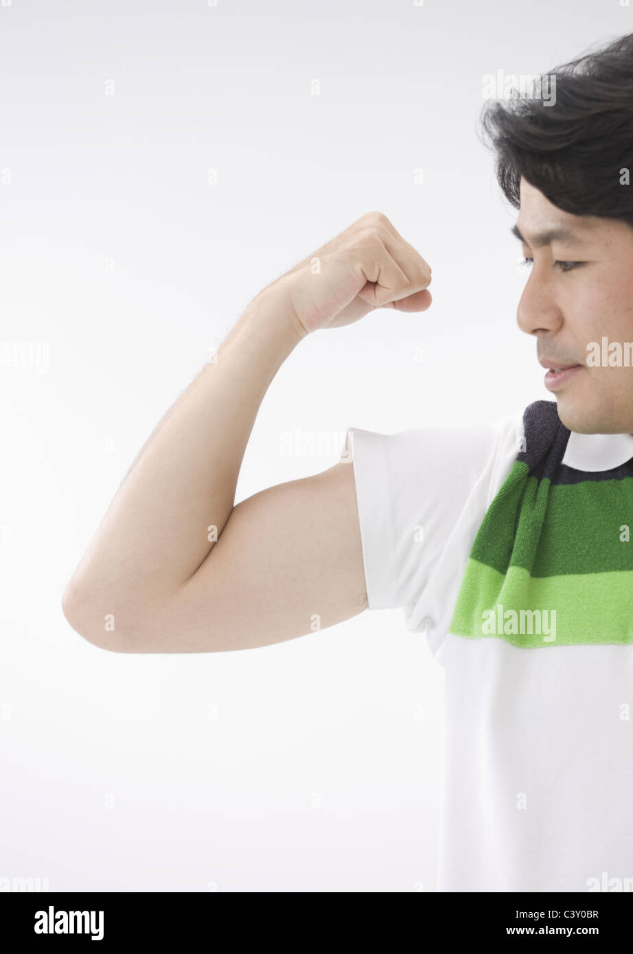 Man flexing arm muscles Stock Photo - Alamy