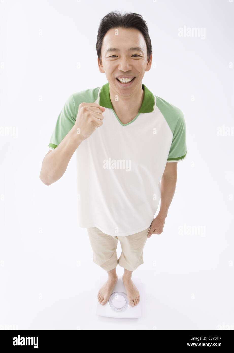 Man standing on scale Stock Photo - Alamy