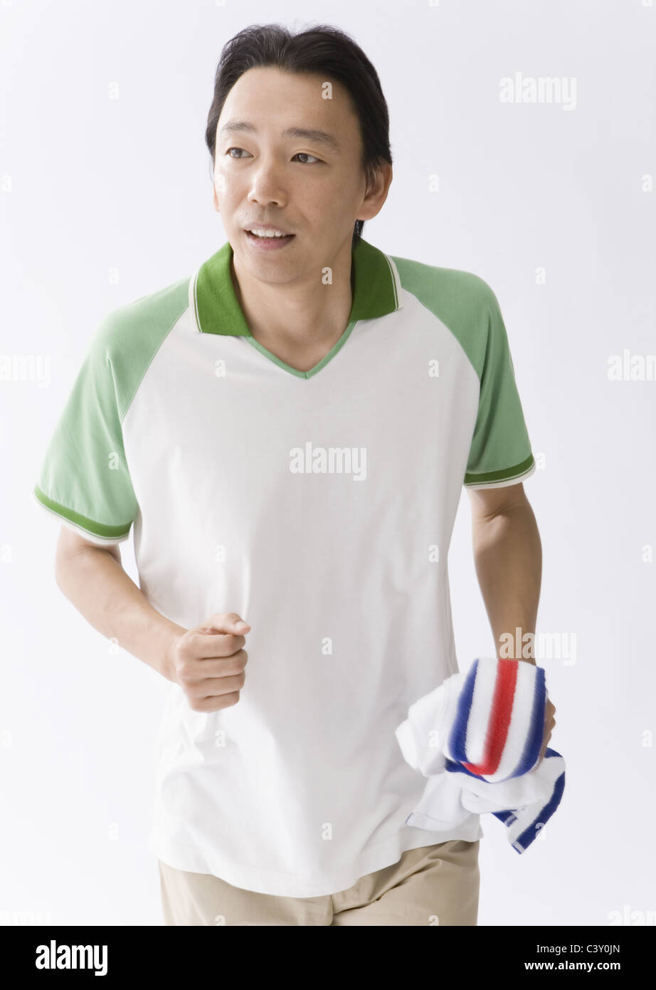 Man holding towel Stock Photo - Alamy