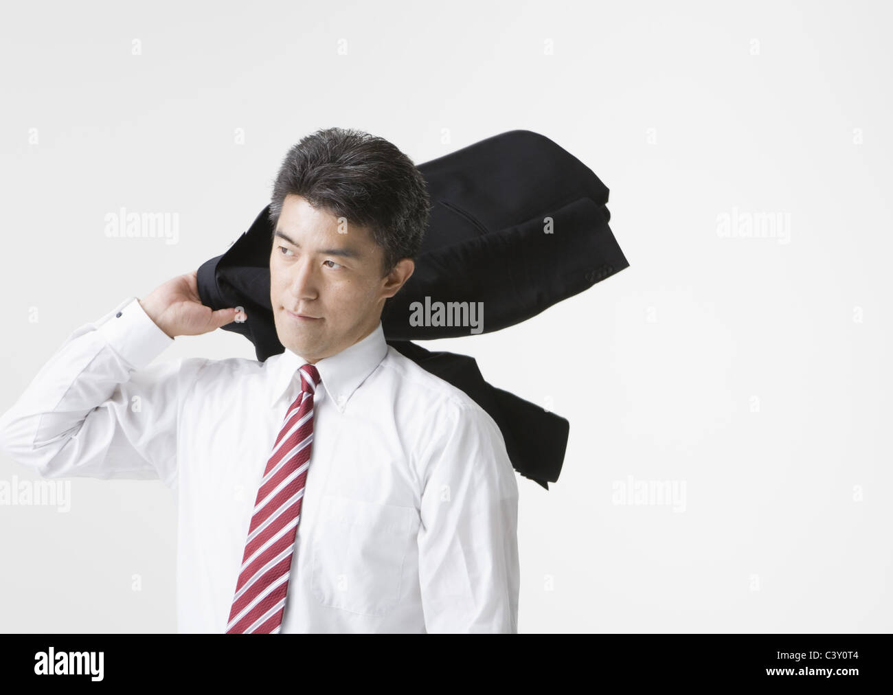 Businessman holding jacket Stock Photo - Alamy