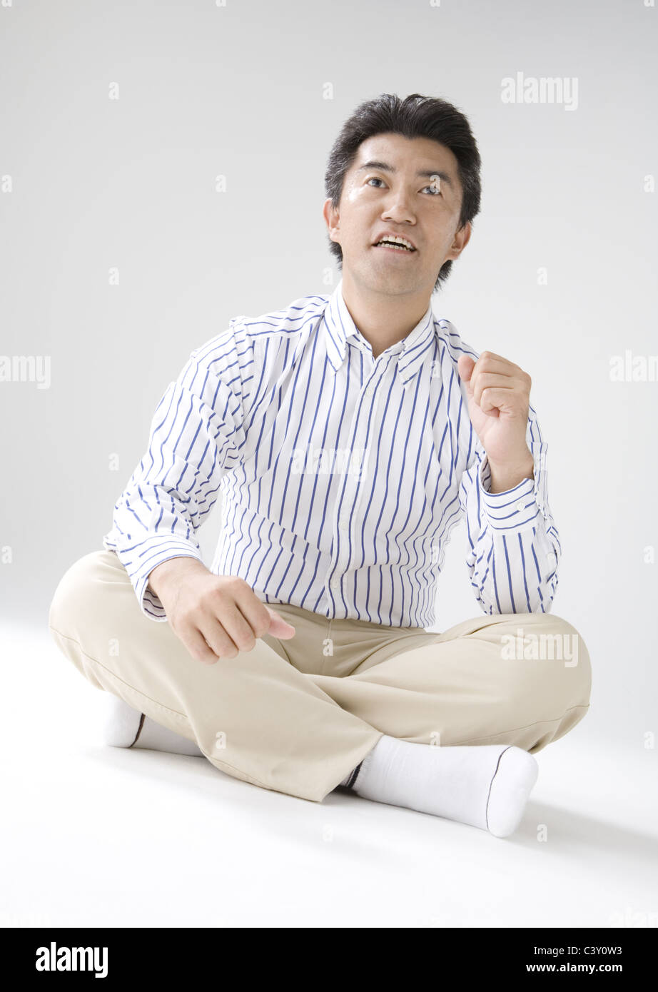 Man sitting with legs crossed Stock Photo - Alamy