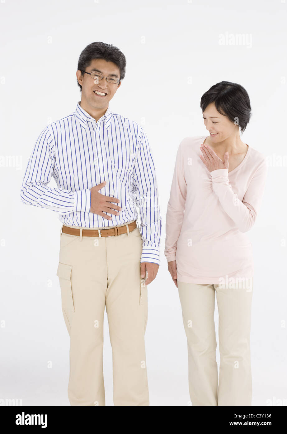 Couple standing and smiling Stock Photo - Alamy
