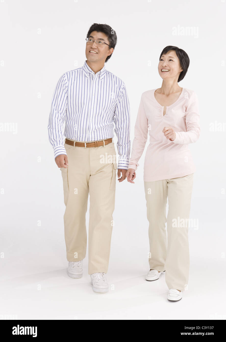 Couple walking together Stock Photo - Alamy
