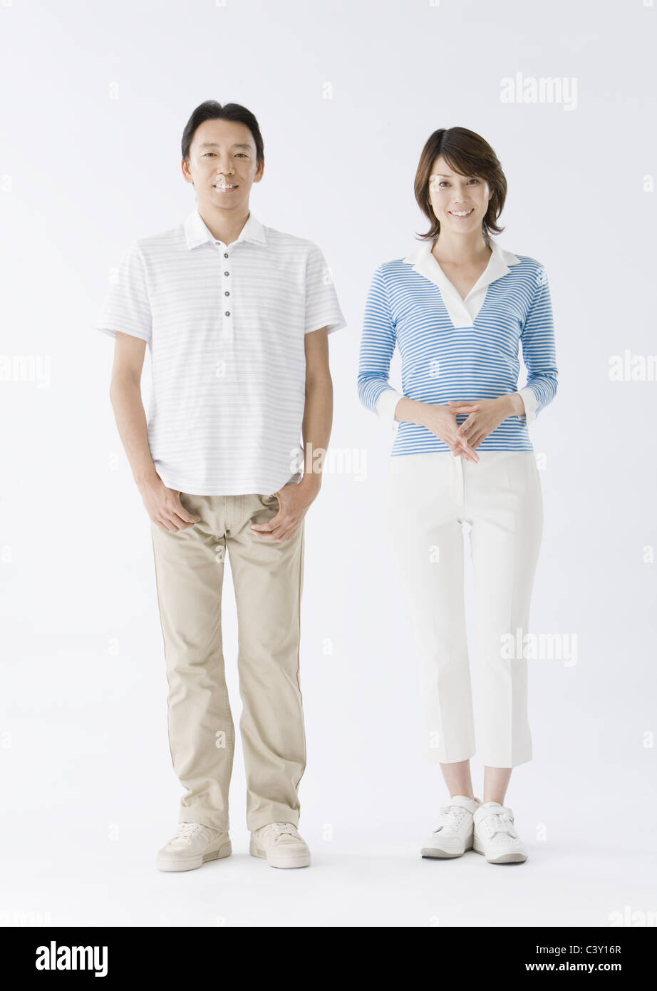 Couple standing side by side Stock Photo - Alamy