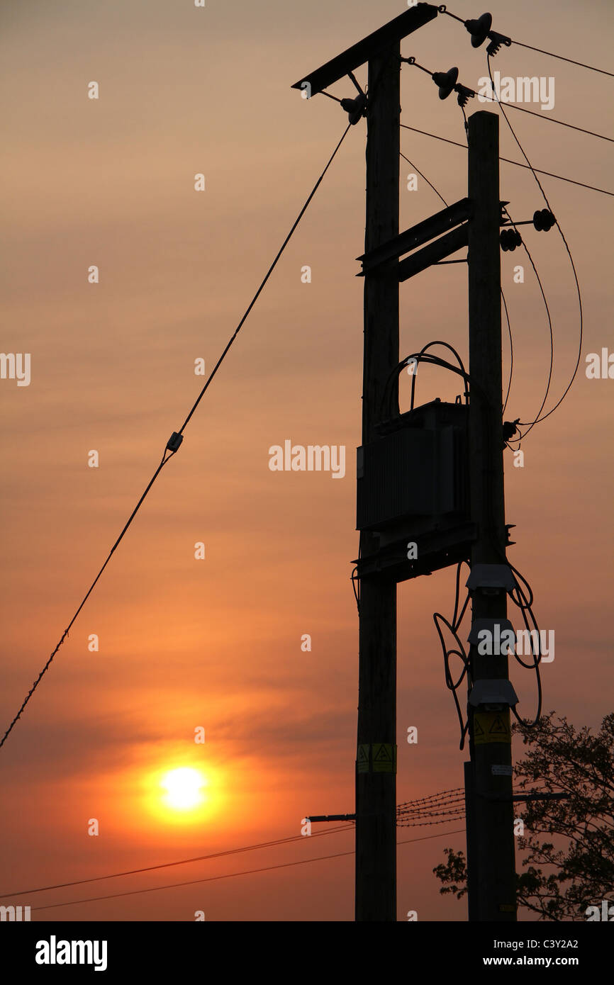 Electric transformer on pole and sunset Stock Photo - Alamy
