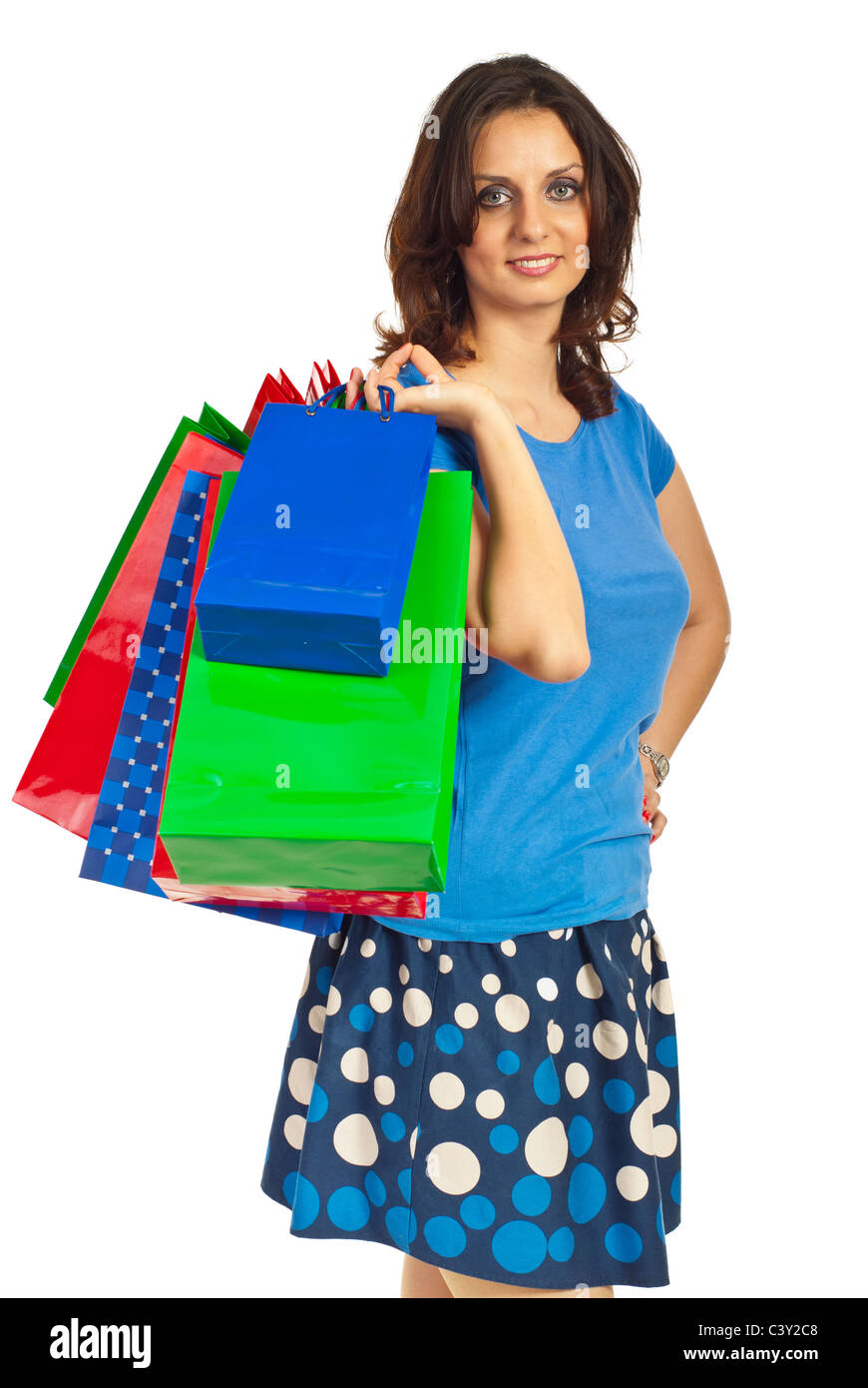 Happy shopper woman standing in semi profile with shopping bags on ...