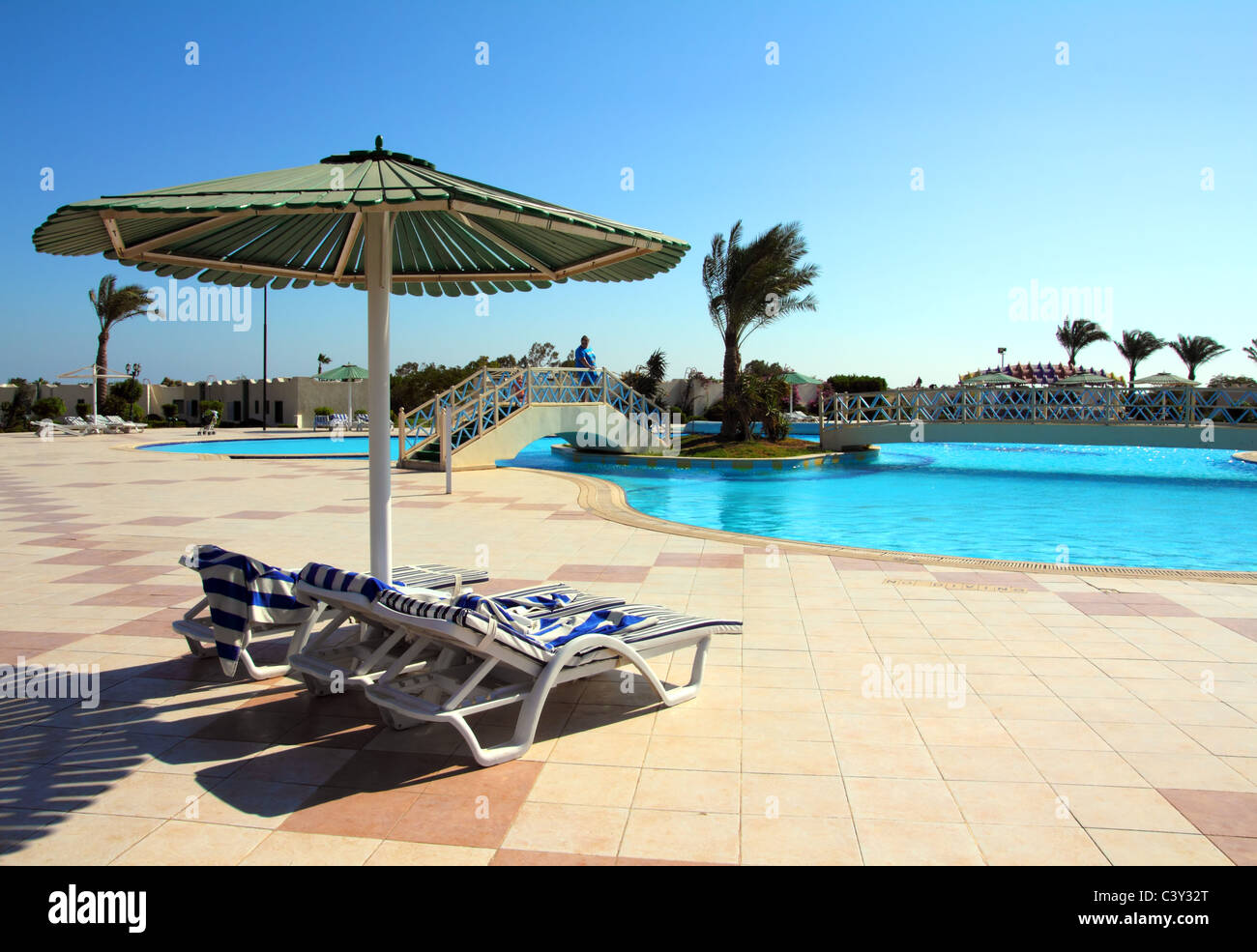 view on parasol and swimming pool in hotel Stock Photo - Alamy
