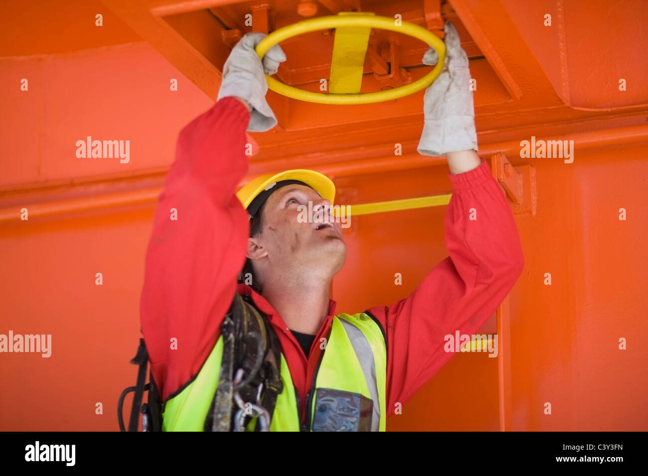 Man working in a harbour Stock Photo - Alamy