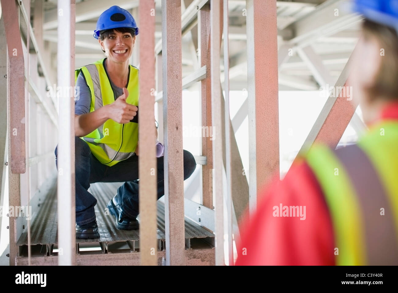 Female architect talkiing to a builder Stock Photo - Alamy