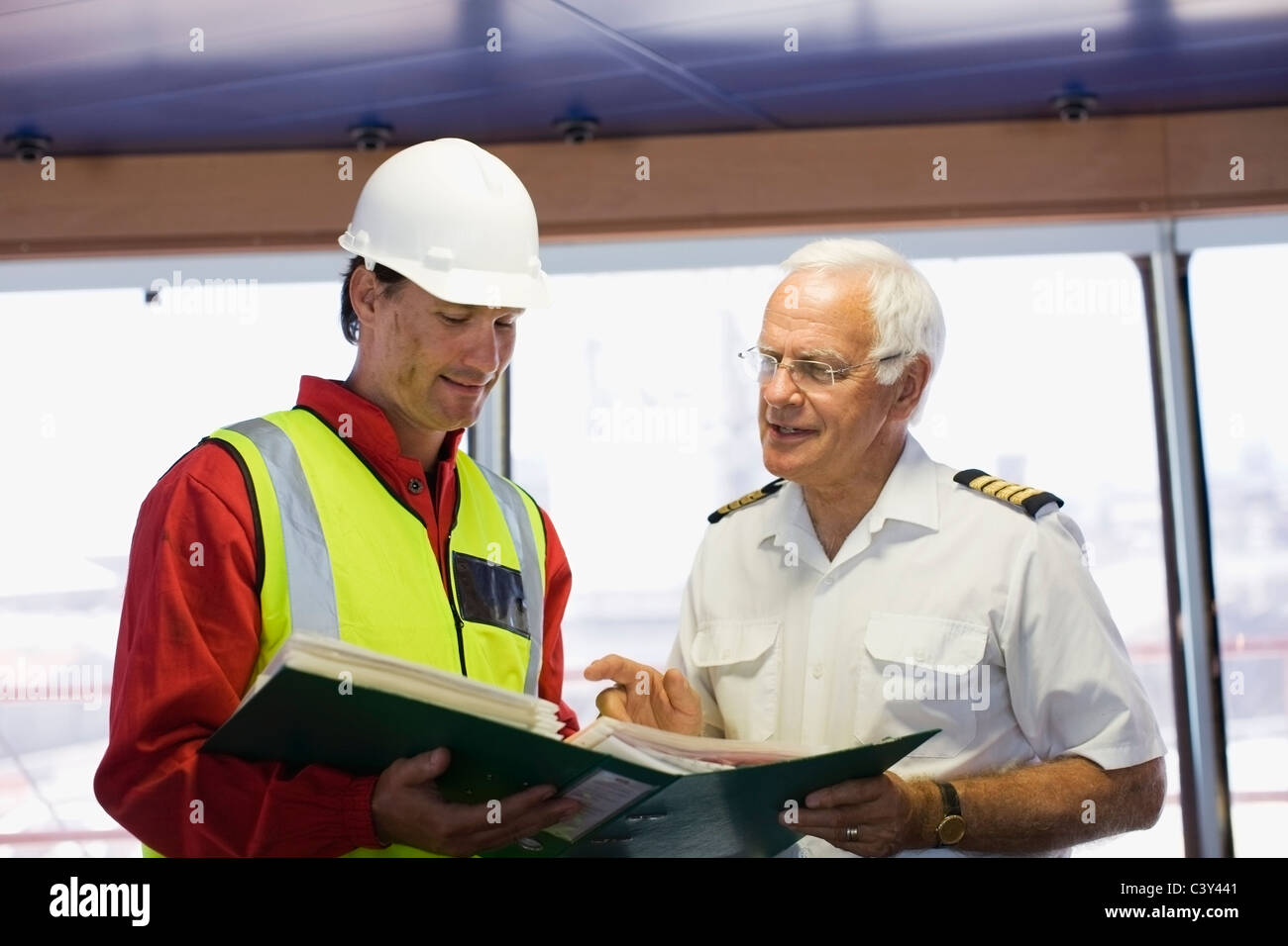 Captain of a ship discussing with a work Stock Photo - Alamy