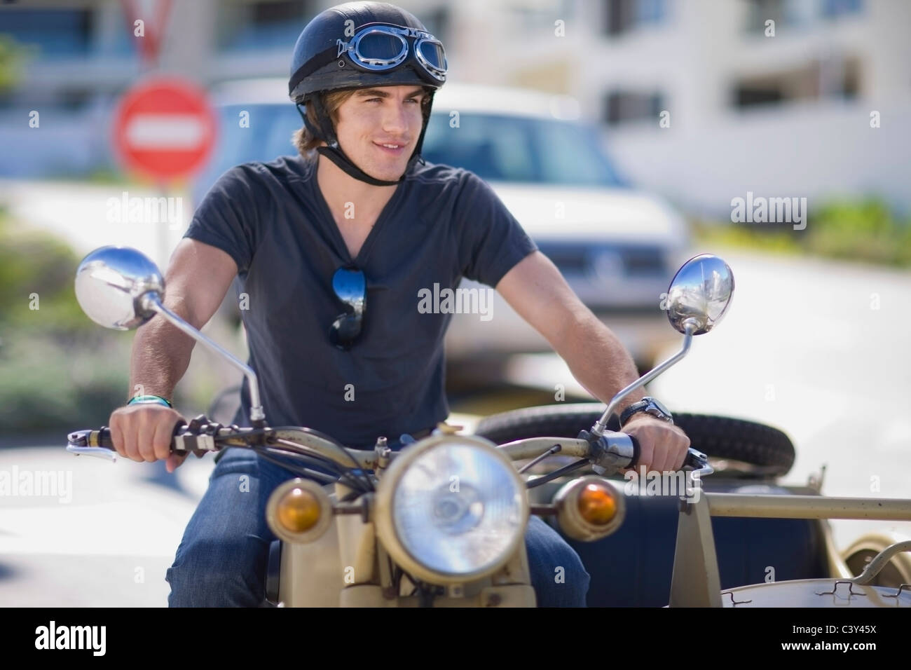 Young man riding a motorbike Stock Photo - Alamy