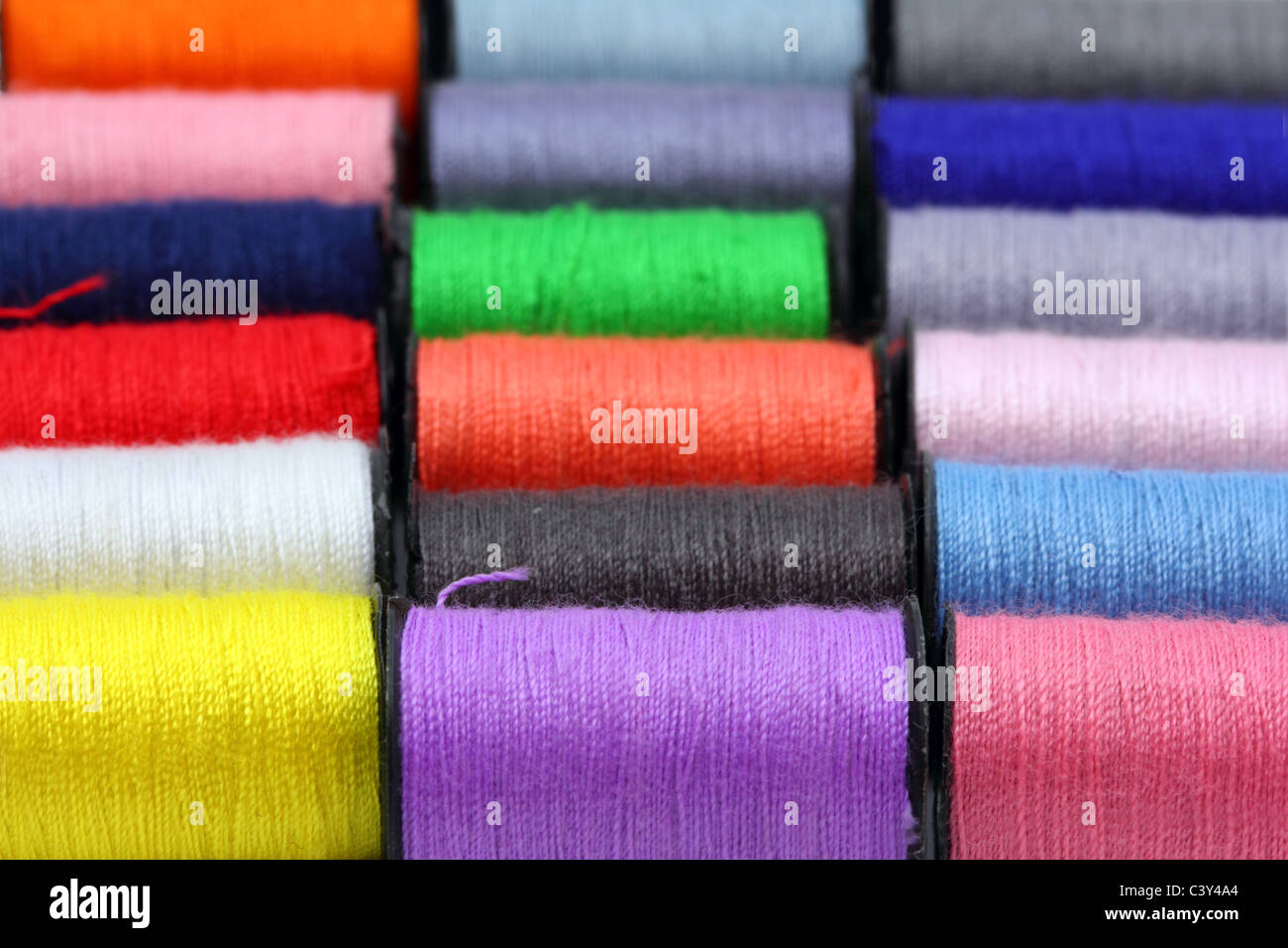 lot of colored thread spools - background Stock Photo - Alamy