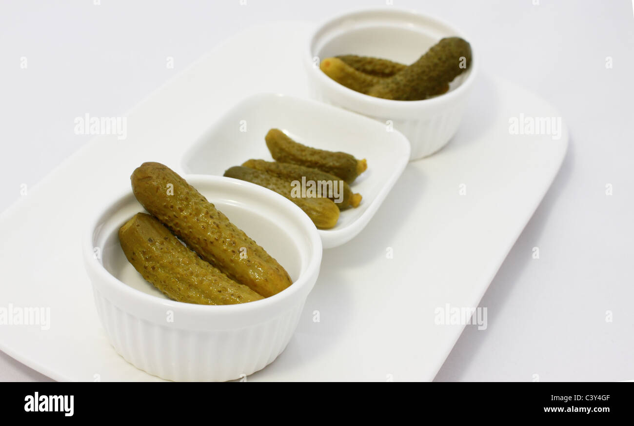 delicious salted pickles on the white dish close up Stock Photo - Alamy
