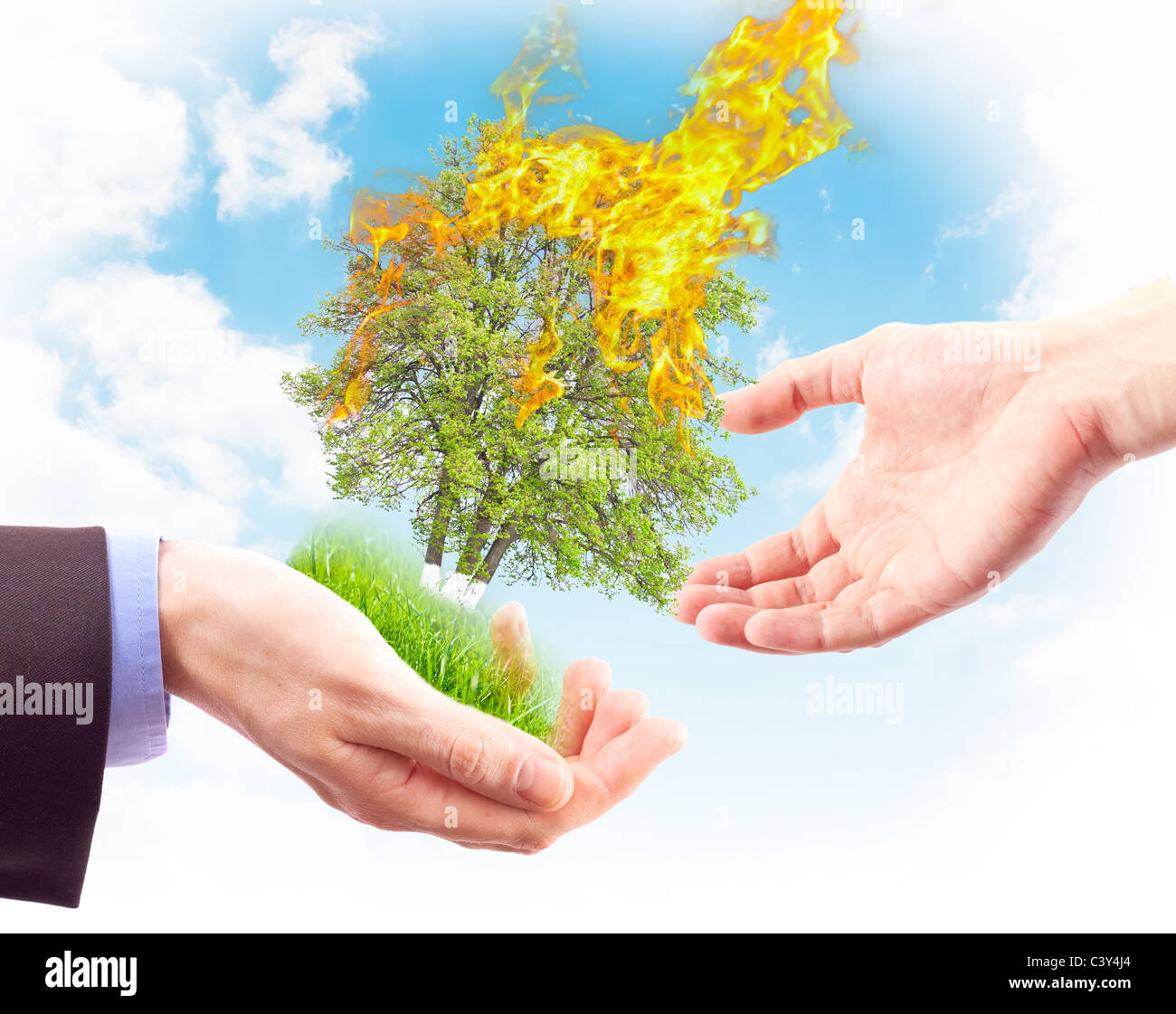 Man's hand gives the other hand, a piece of nature in flames. Concept ...