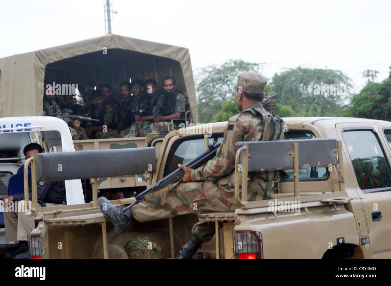 Army soldiers sit alert on vehicles when they are moving towards the ...