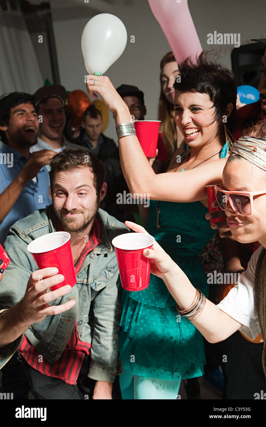 People dancing at party with plastic cups Stock Photo - Alamy