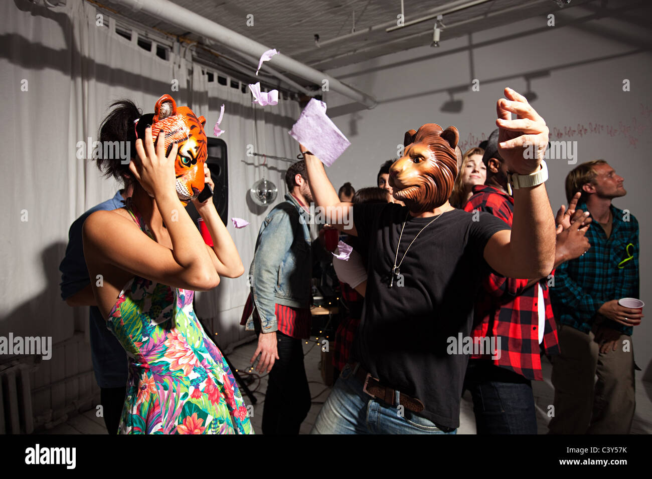 People wearing lion and tiger masks dancing at party Stock Photo - Alamy