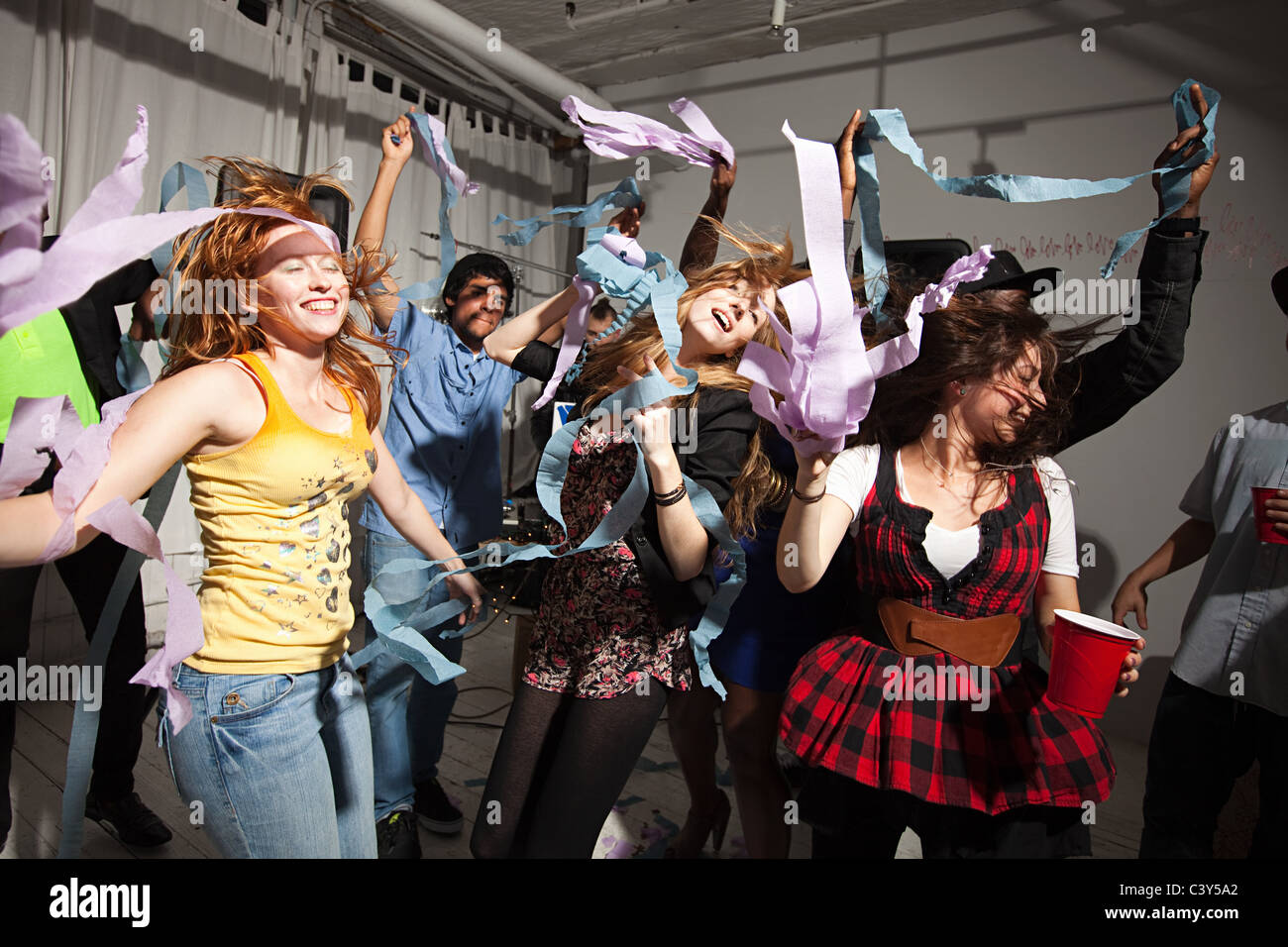 People dancing at party with streamers Stock Photo - Alamy
