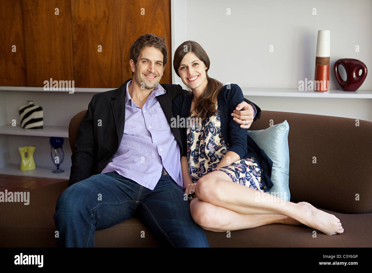 Couple sitting on sofa, portrait Stock Photo - Alamy