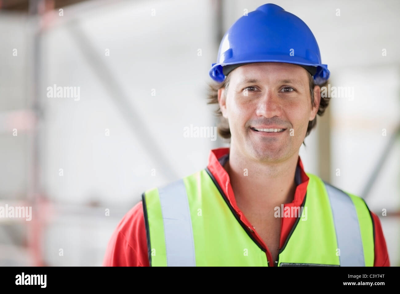 Smiling worker with hat Stock Photo - Alamy