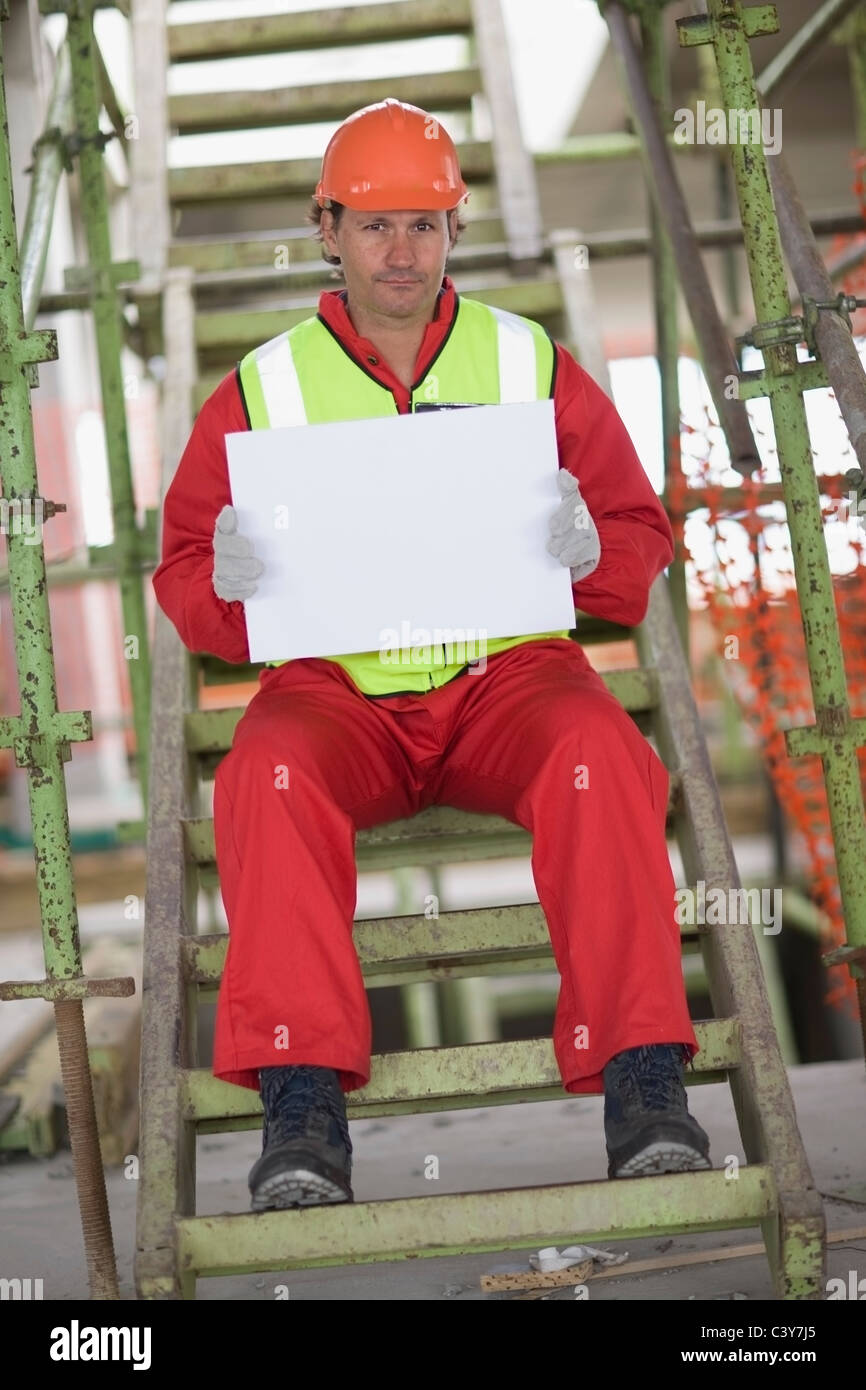Worker holding an empty sheet of paper Stock Photo - Alamy