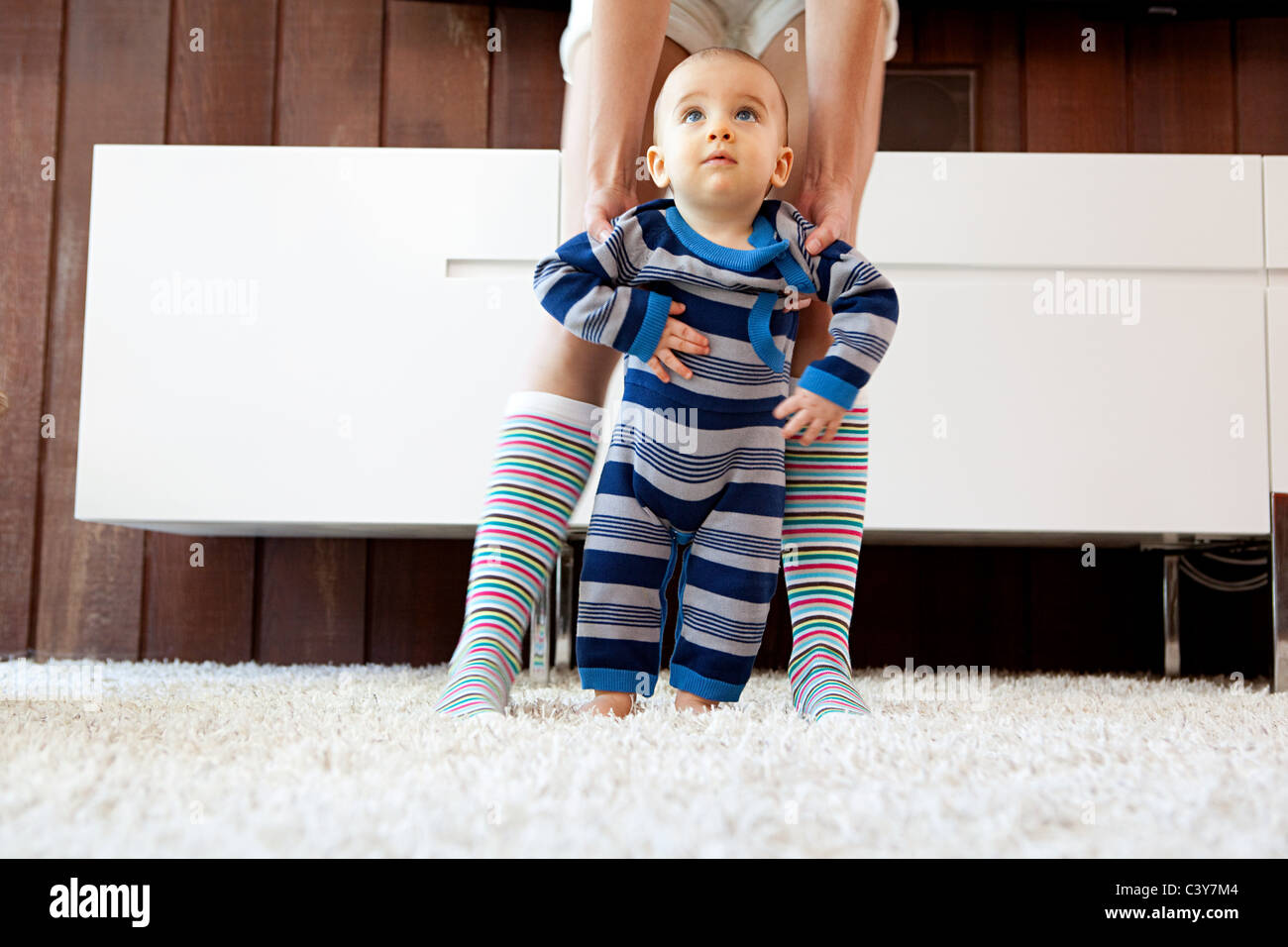 Mother helping baby boy take hi-res stock photography and images - Alamy