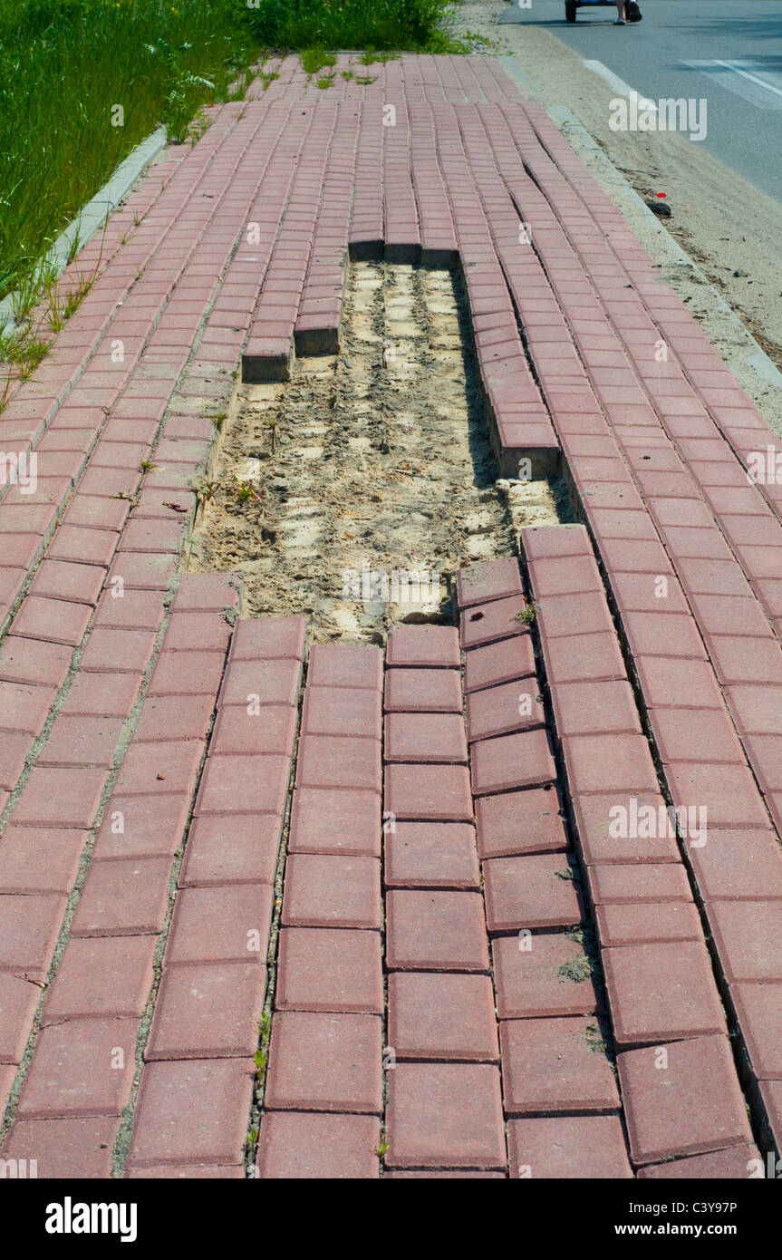 broken paving stones, a hole in the sidewalk Stock Photo - Alamy
