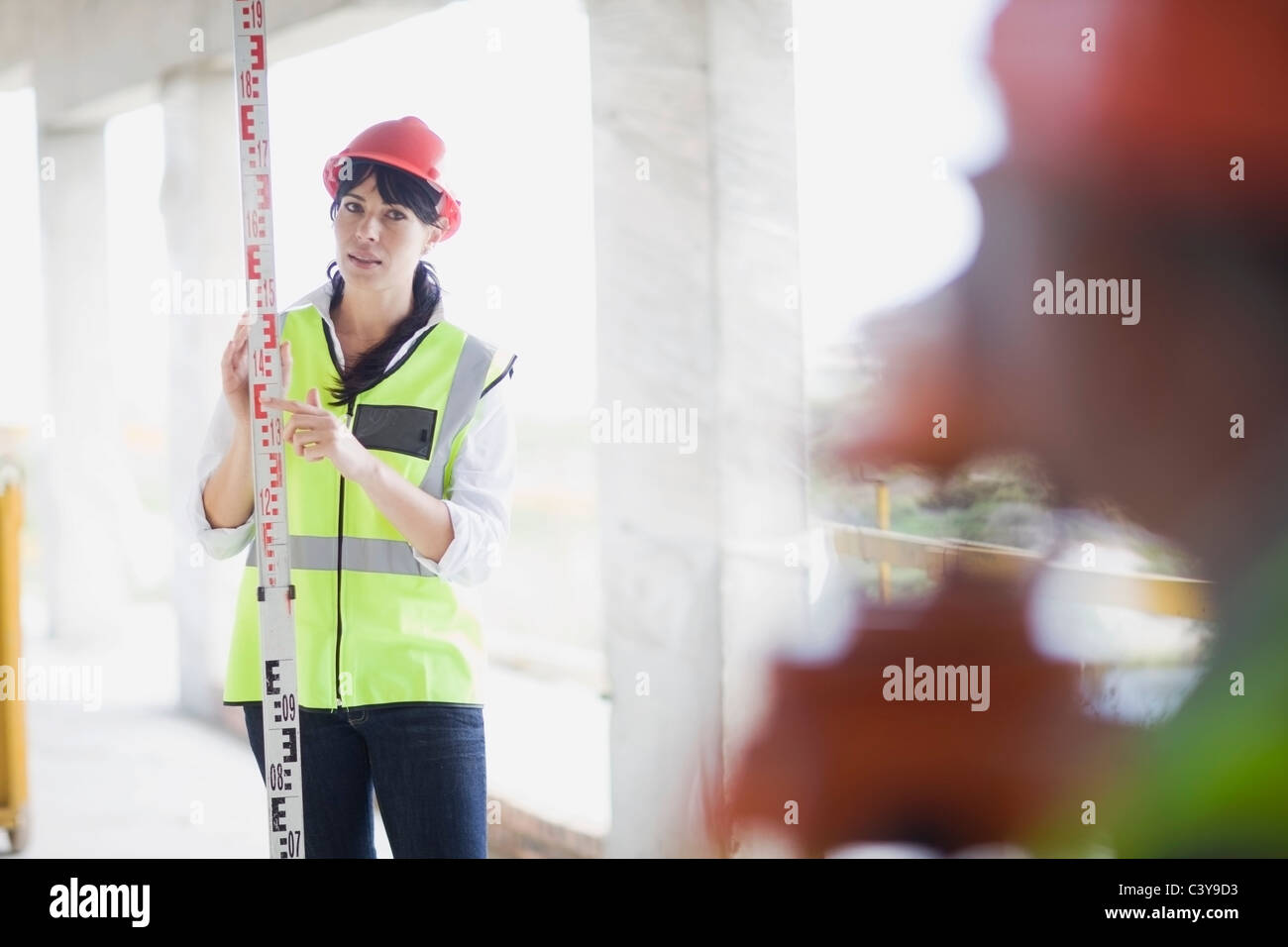 Building worker doing some measurings Stock Photo - Alamy