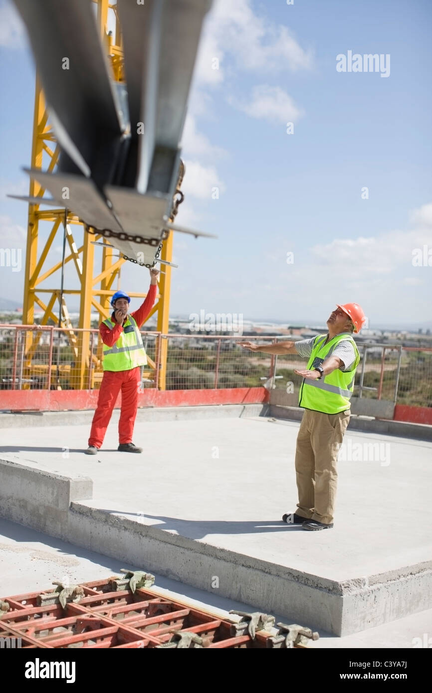 Crane and workers on construction site Stock Photo - Alamy