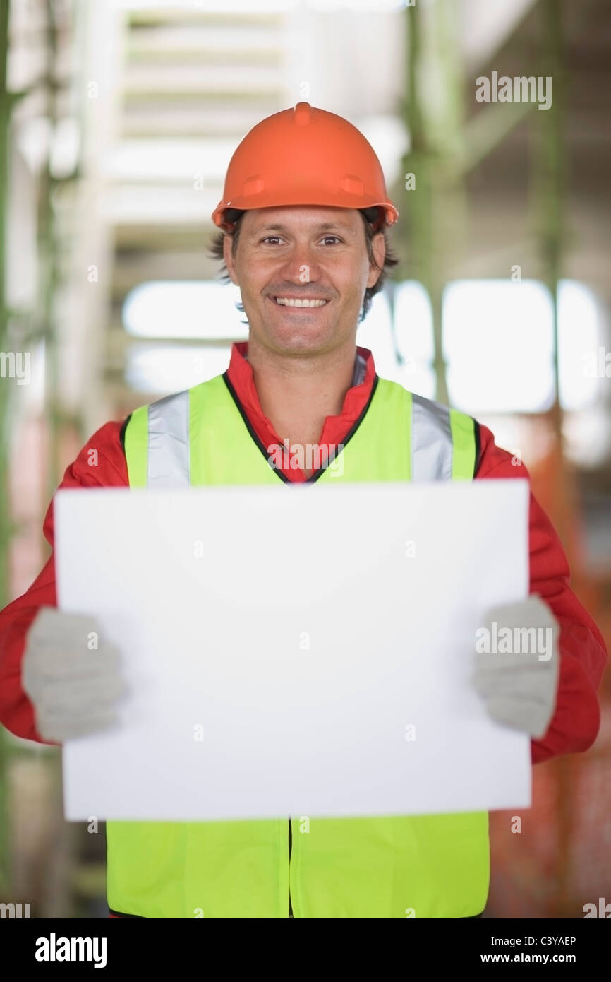 Worker holding an empty sheet of paper Stock Photo - Alamy