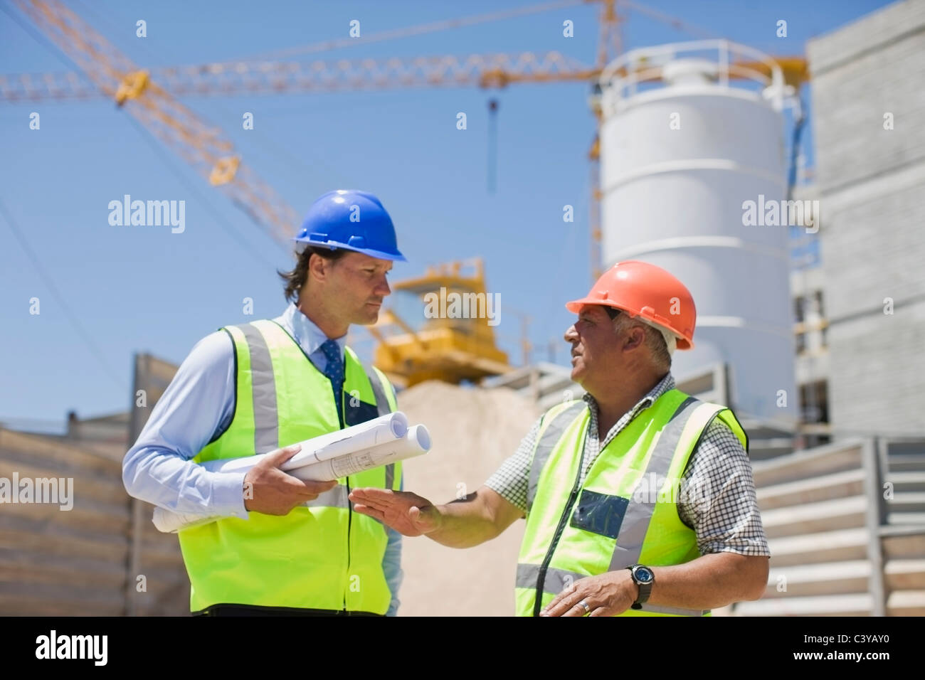 Architect talking to a building worker Stock Photo - Alamy