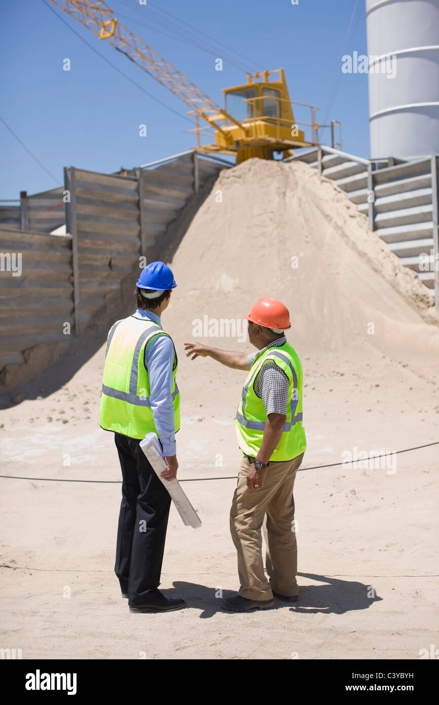 Architect inspecting the building lot Stock Photo - Alamy