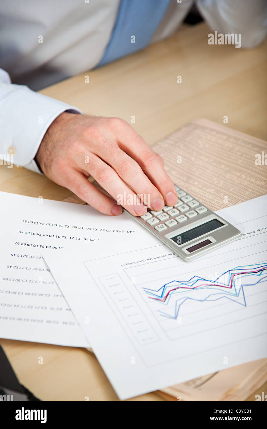 Office worker using calculator Stock Photo - Alamy
