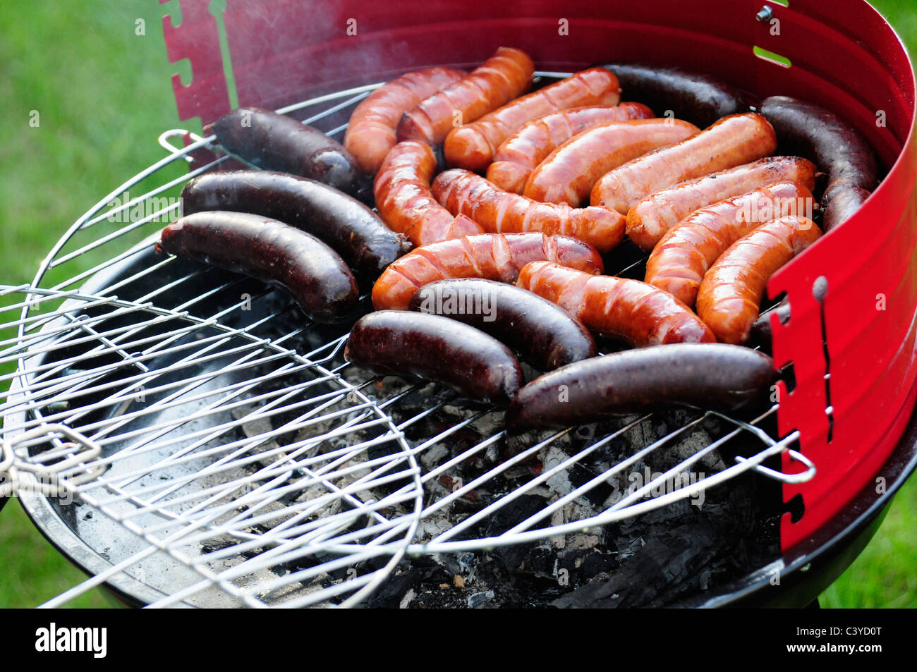 Preparation of meat on grill Stock Photo - Alamy